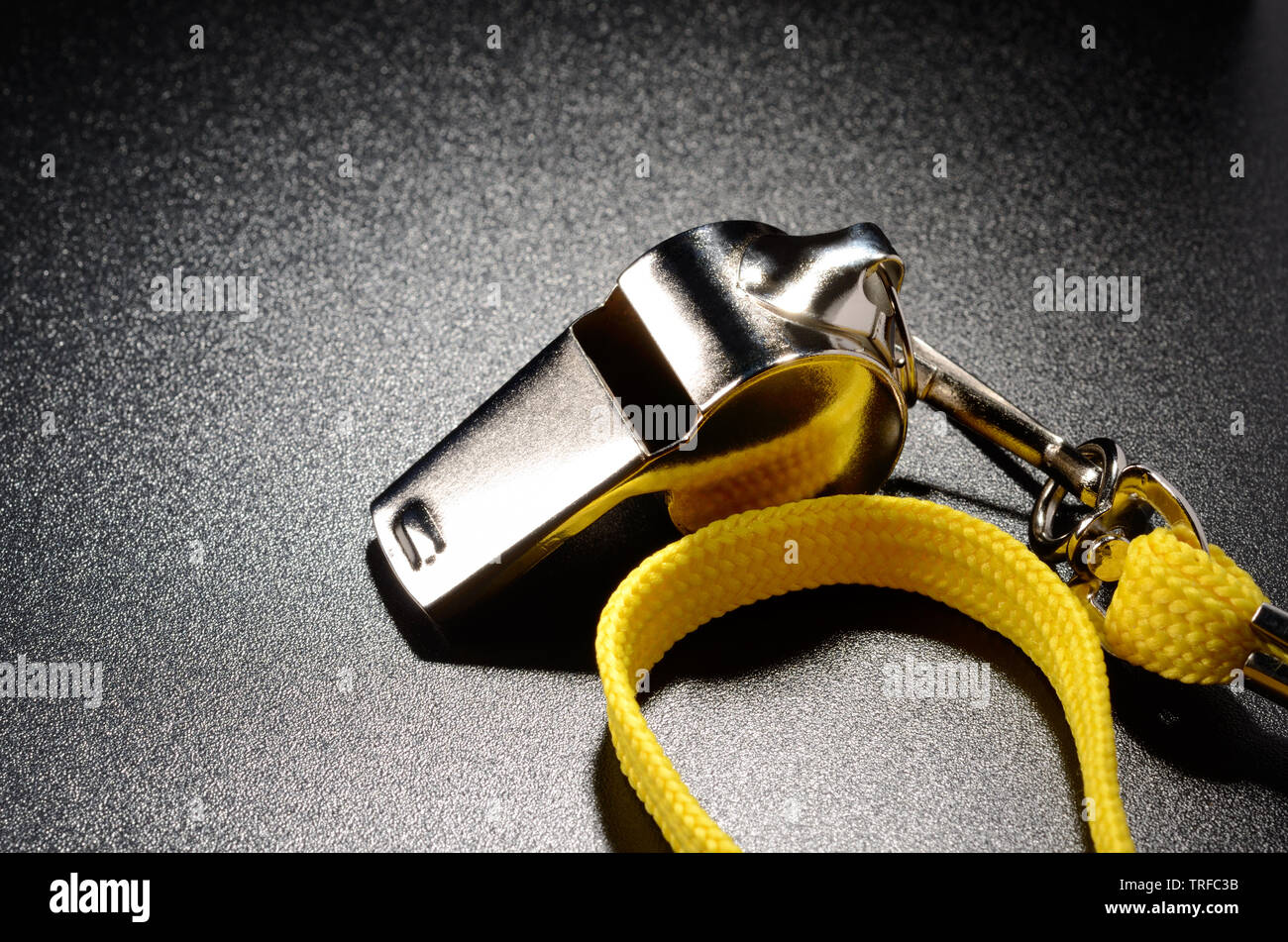 Metal whistle on a black grained surface Stock Photo - Alamy