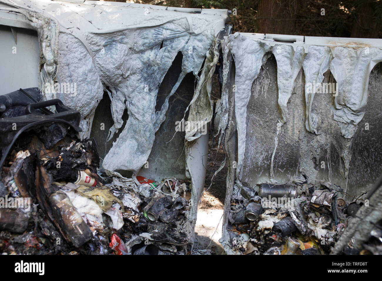 Strange forms of melted pvc garbage cans after a fire Stock Photo - Alamy