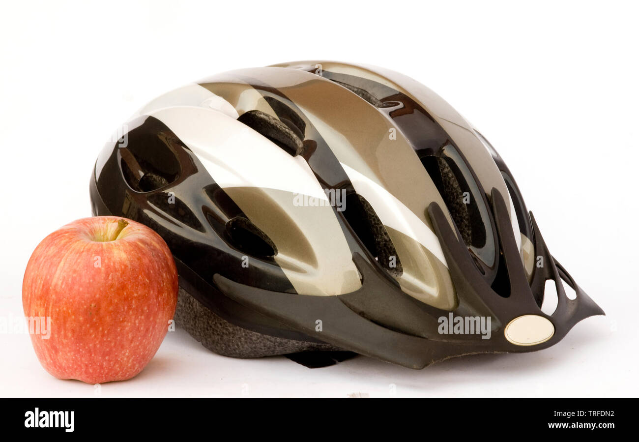 Bicycle helmet and apple Stock Photo - Alamy