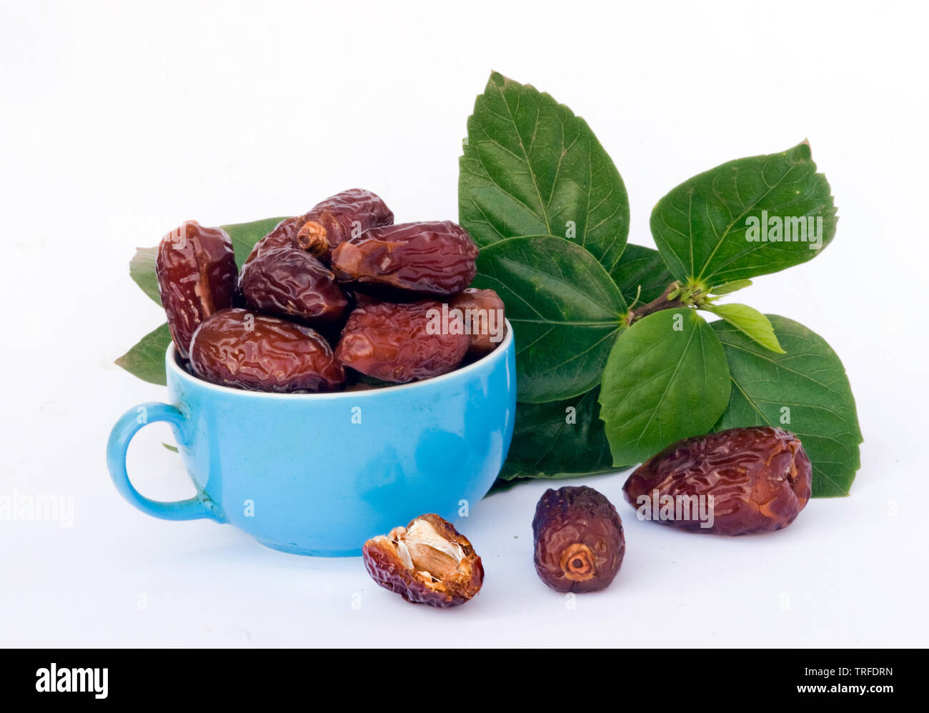 Blue cap full of dried dates Stock Photo - Alamy