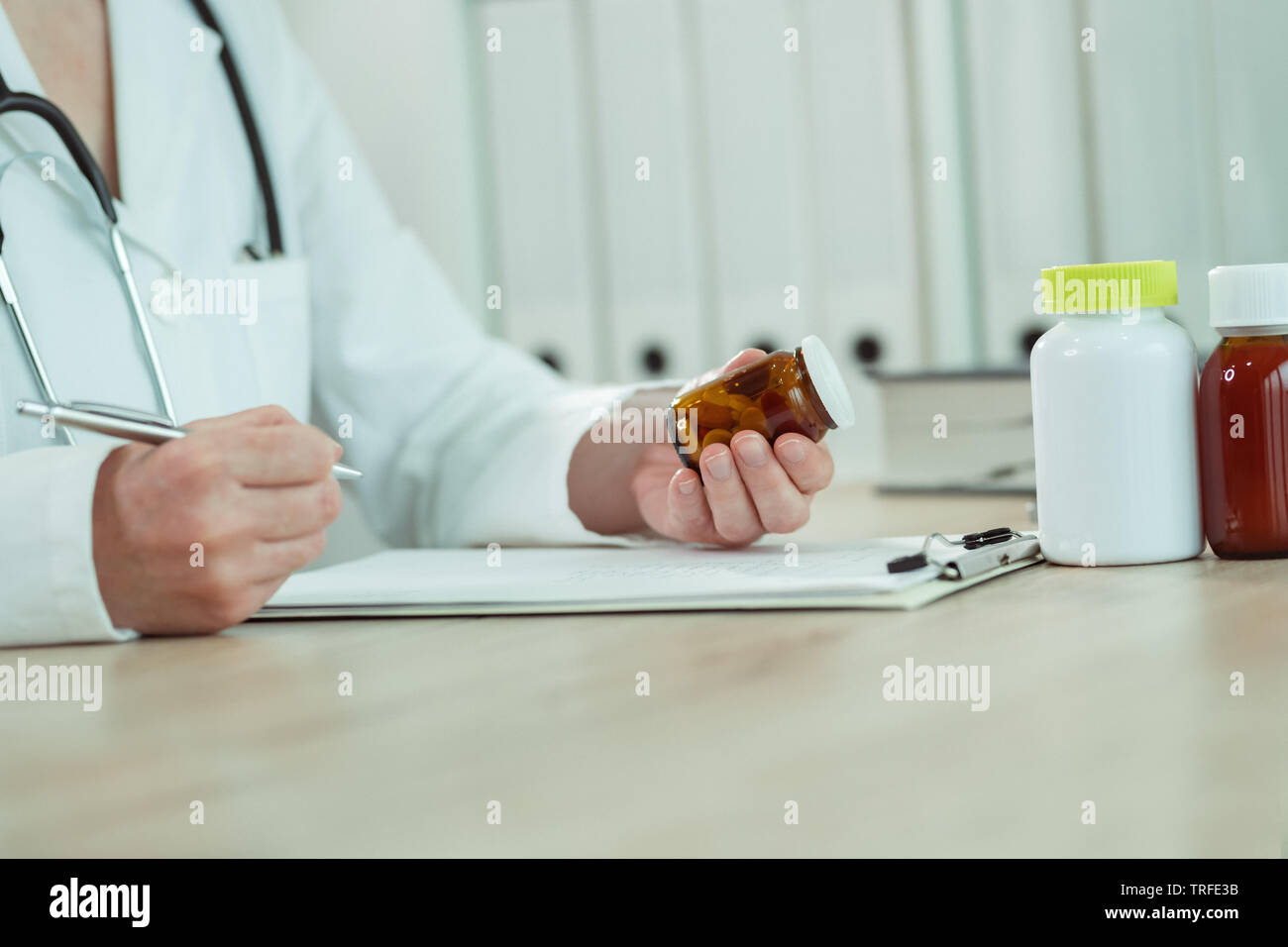 Doctor writing generic drugs prescription in medical office Stock Photo ...