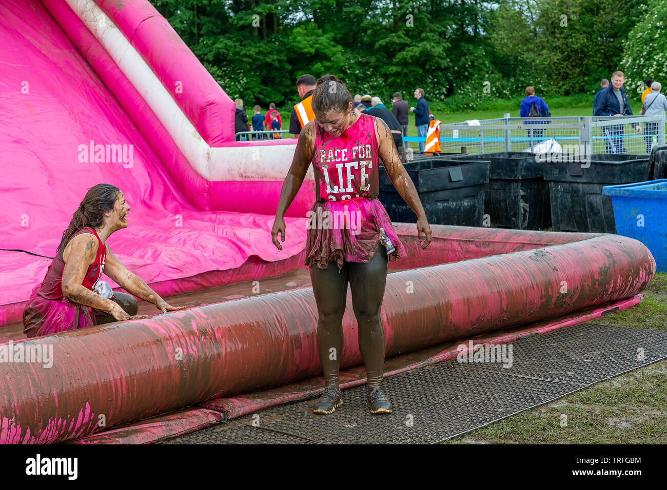 Mud run crawling exercise for two women hi-res stock photography and ...