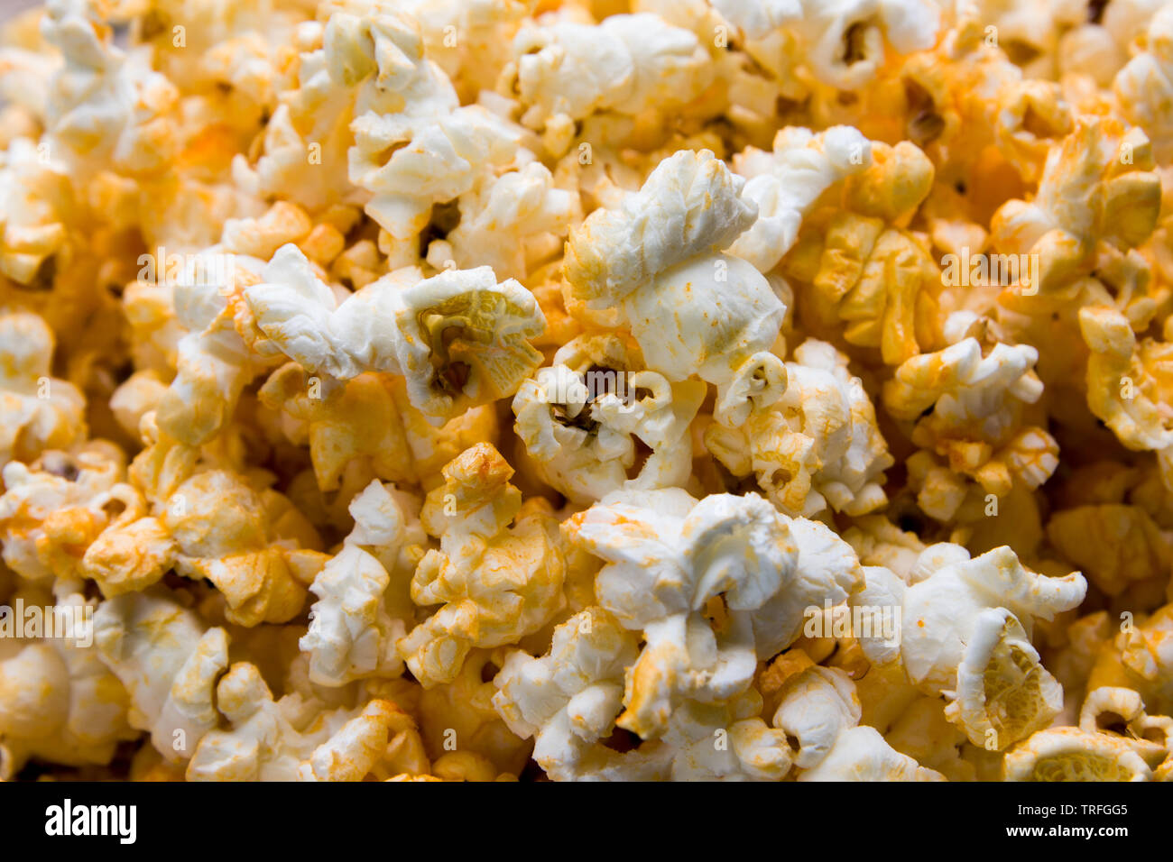 The cheesy popcorn top view background Stock Photo - Alamy