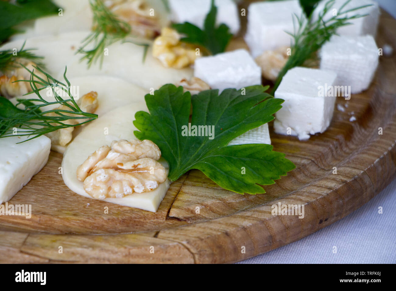 Extreme close-up of different types of cheeses, nuts, herbs and honey ...