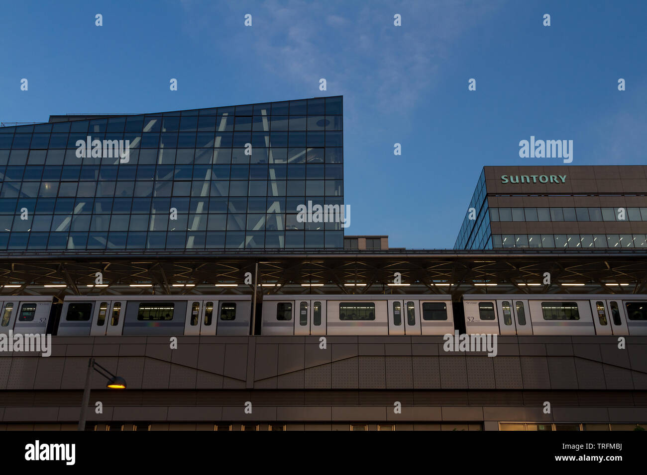 A Yurikamome Line train in front of modern office buildings in Odaiba ...