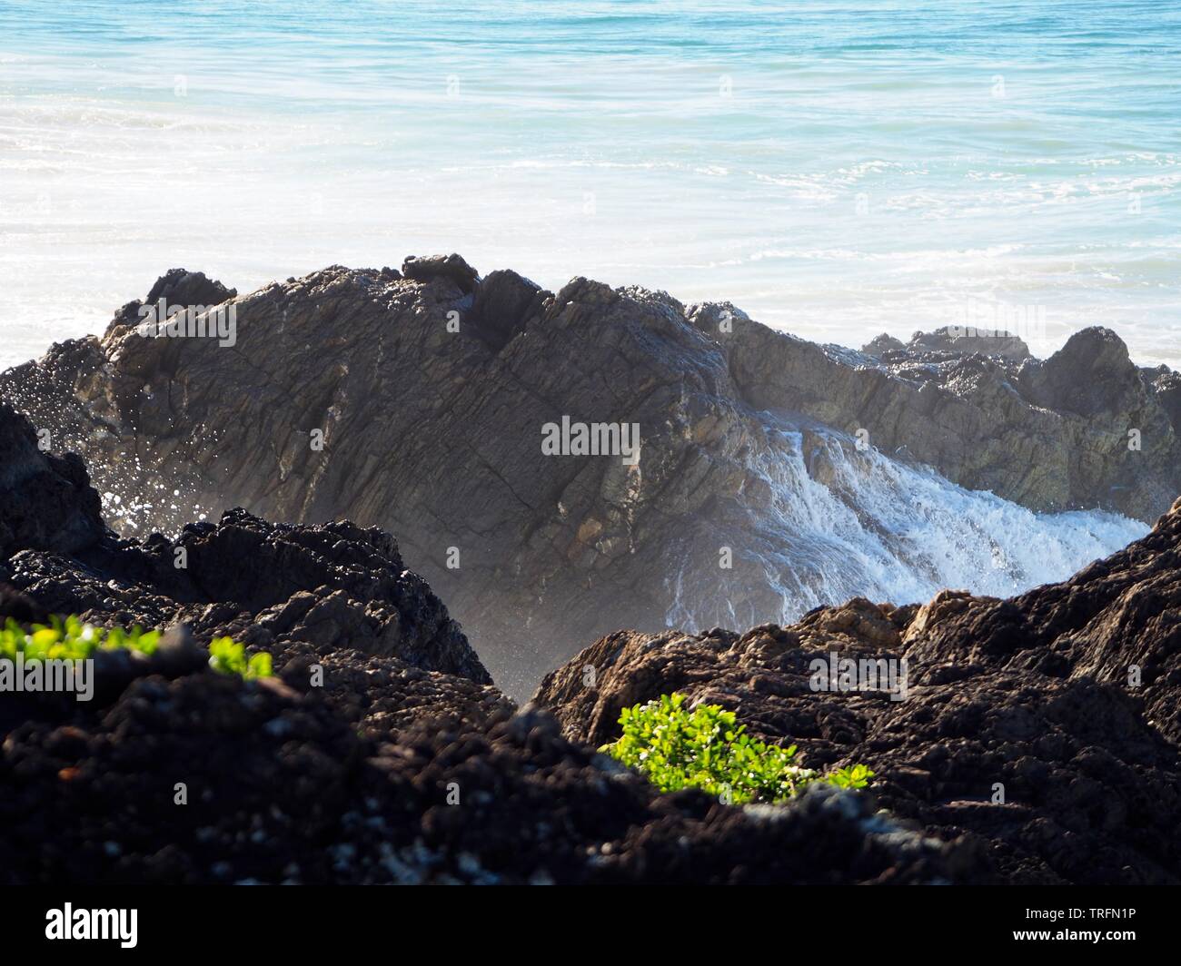 Ocean backdrop for water running down rocks from waves Stock Photo - Alamy