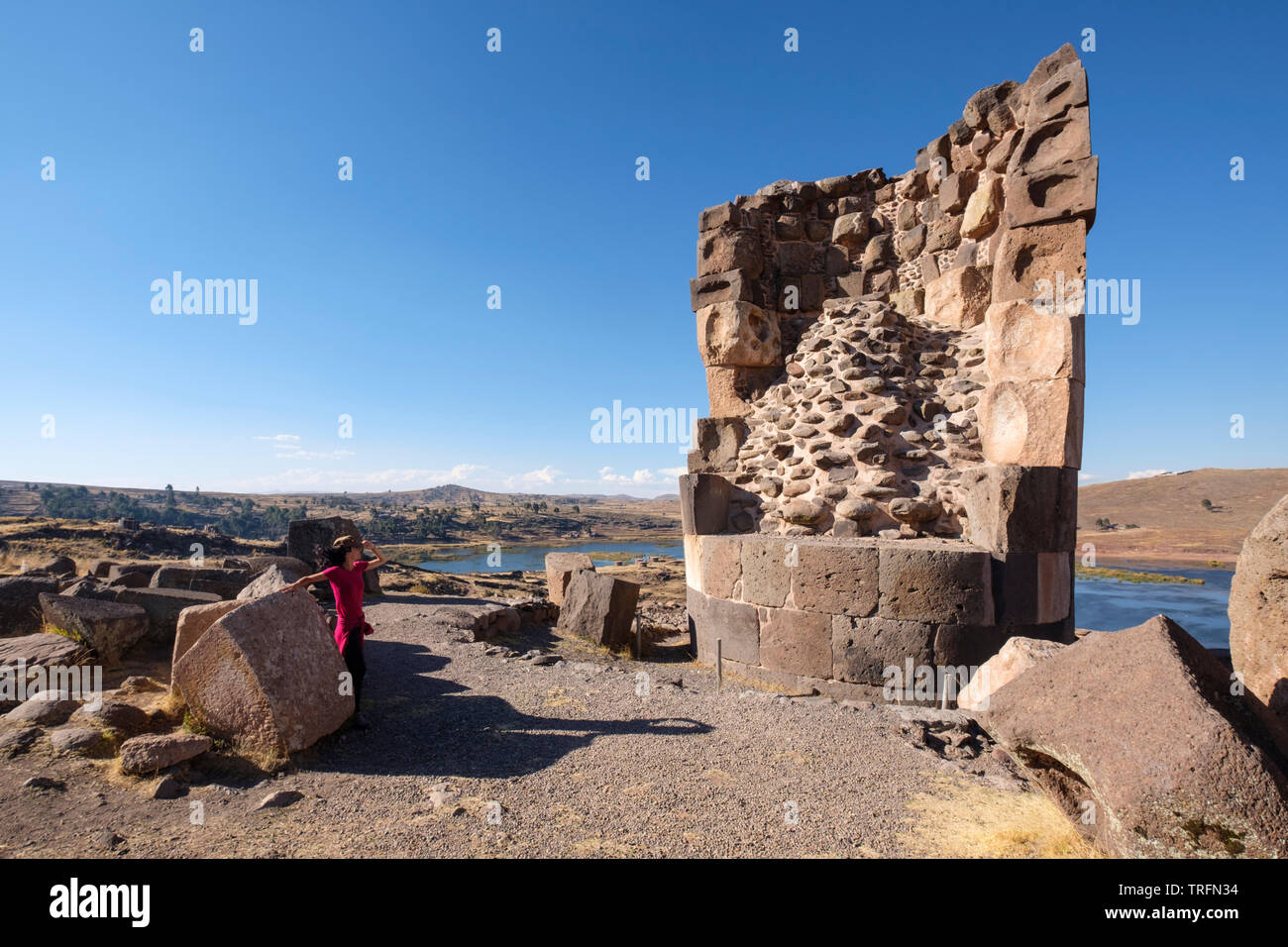 Young woman looking at one of the impressive burial towers called ...