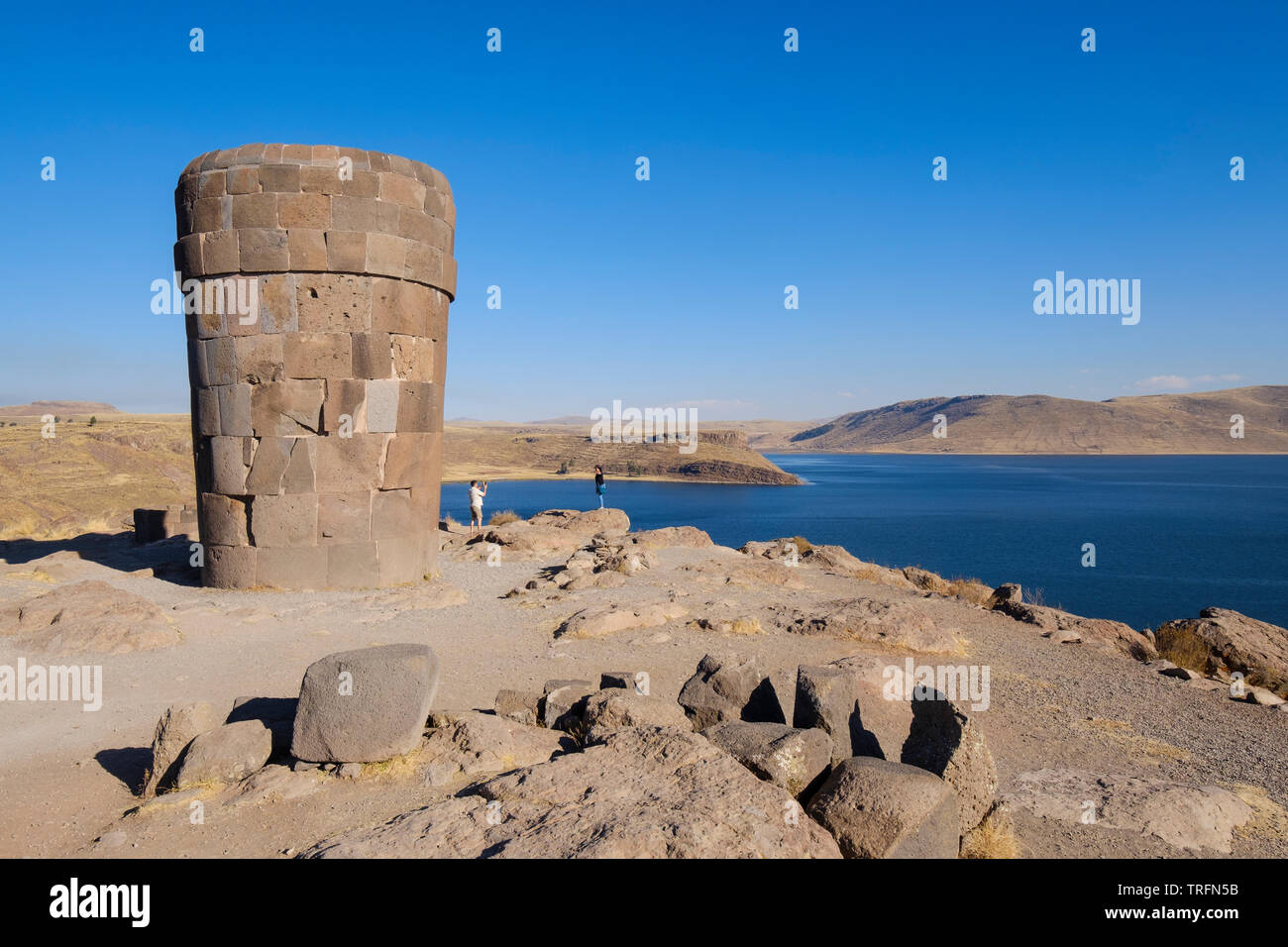 Visitors taking pictures at some of the pre-Inca burial towers called ...