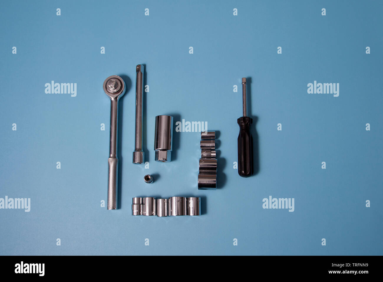 Metal ratchet and sockets against blue background with copy space Stock ...