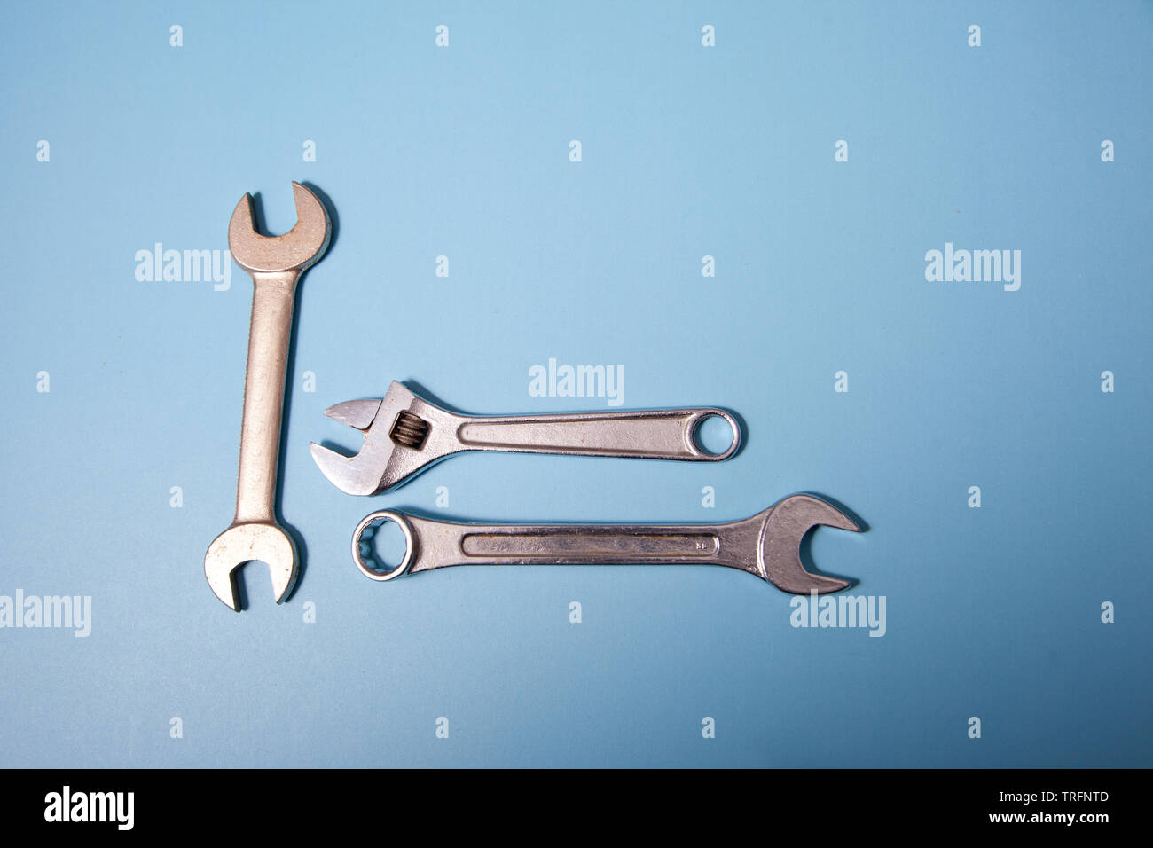 A variety of metal wrenches viewed along the handle portion, ready for ...