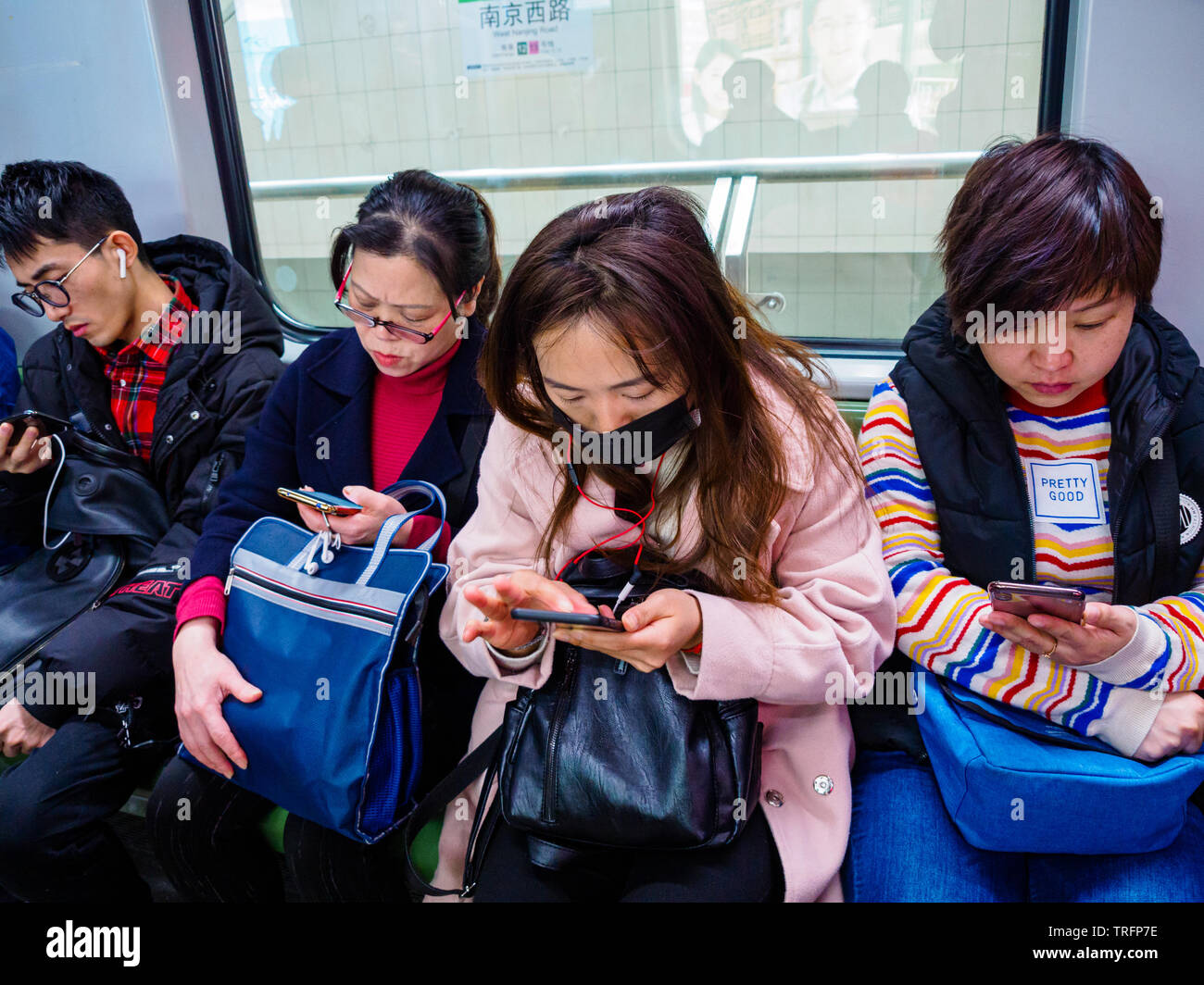 SHANGHAI, CHINA - 12 MAR 2019 - a row of commuters on the Shanghai ...