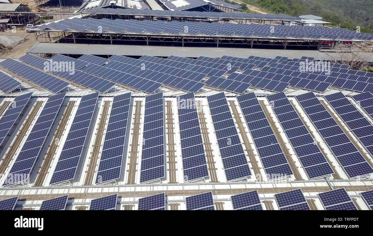 Solar panels spread across an industrial roof - Aerial image Stock ...