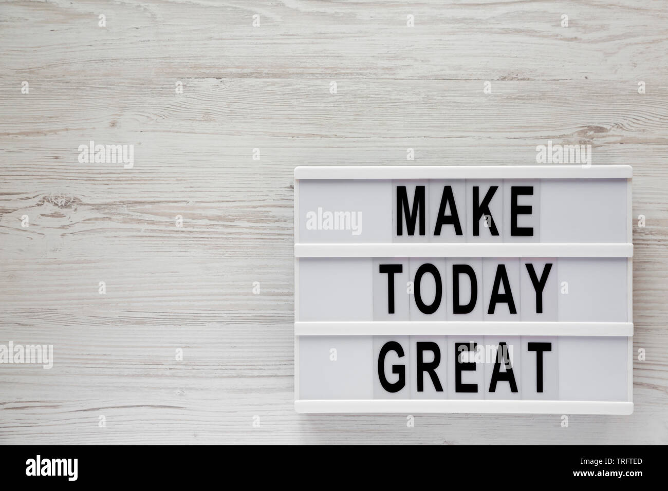 'Make today great' words on a light box over white wooden background ...