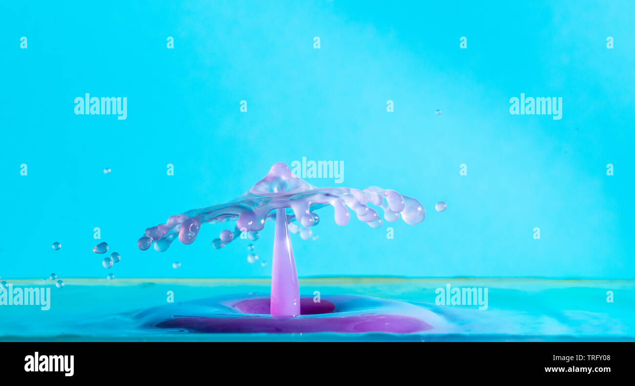 water drop falling and impacting a body of water after hitting the ...