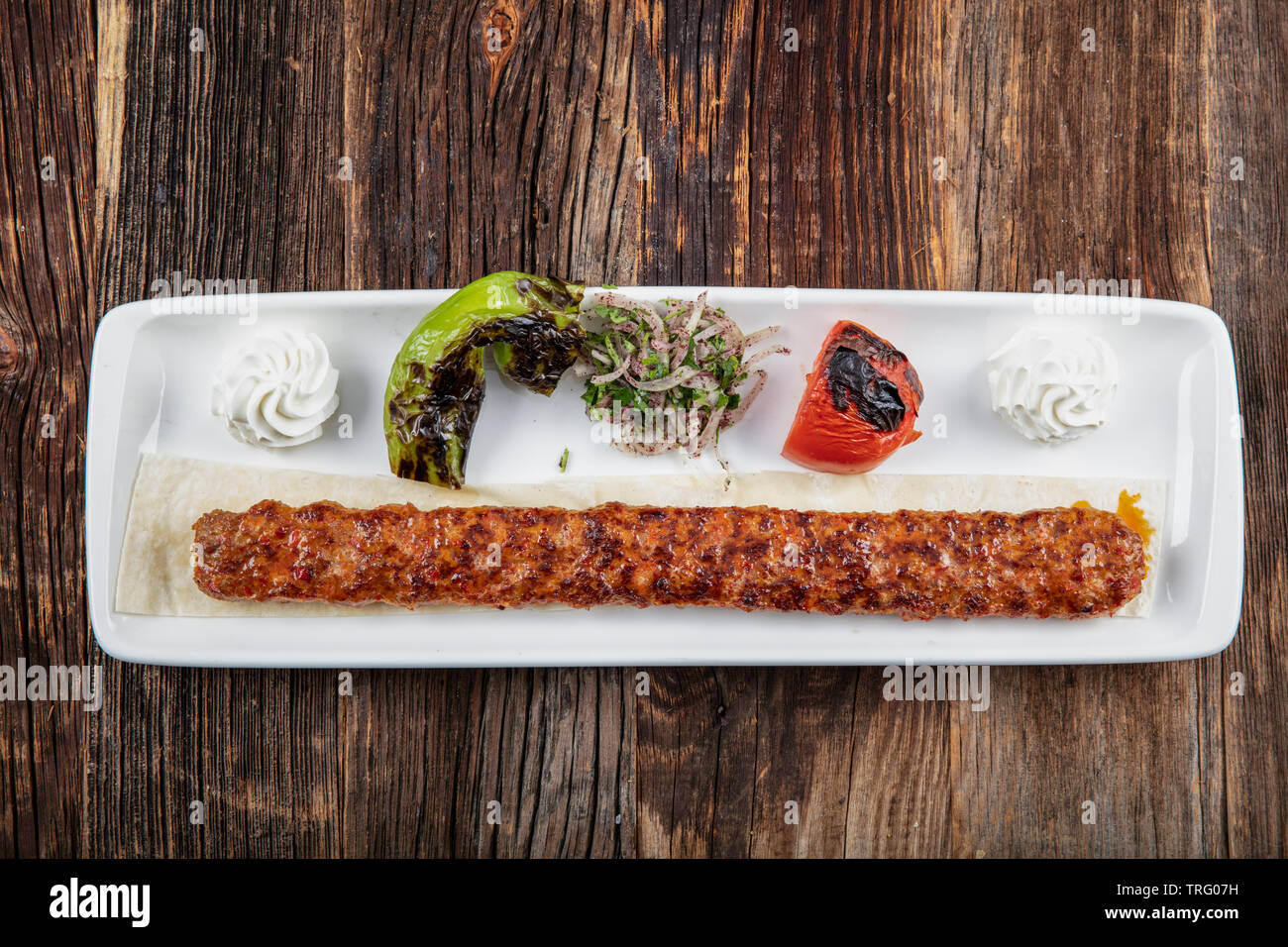 Minced lamb kebab with vegetables ( Turkish Cuisine Adana Kebab Stock ...