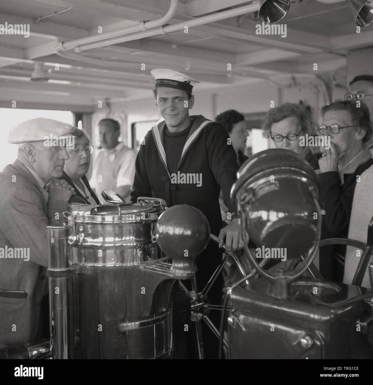 1950s, historical, passengers beside a uniformed seaman inside the ...