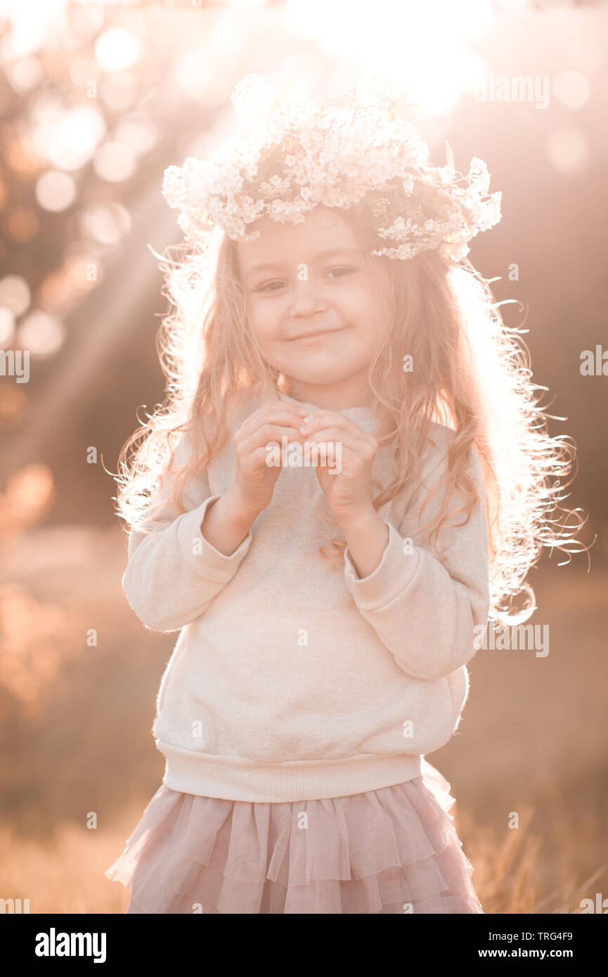 Sweet baby girl standing in sun light outdoors Stock Photo - Alamy