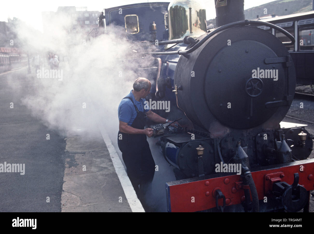 Applying oil from an oil can on steam locomotive at Douglas Railway ...