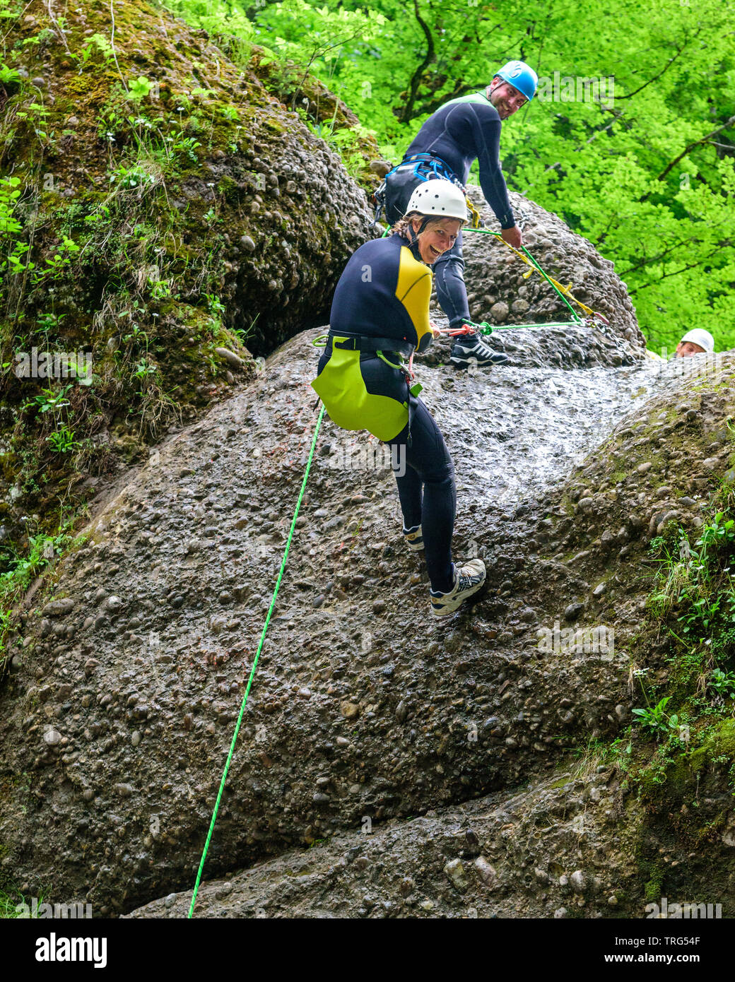 Woman climbing rock waterfall hi-res stock photography and images - Alamy