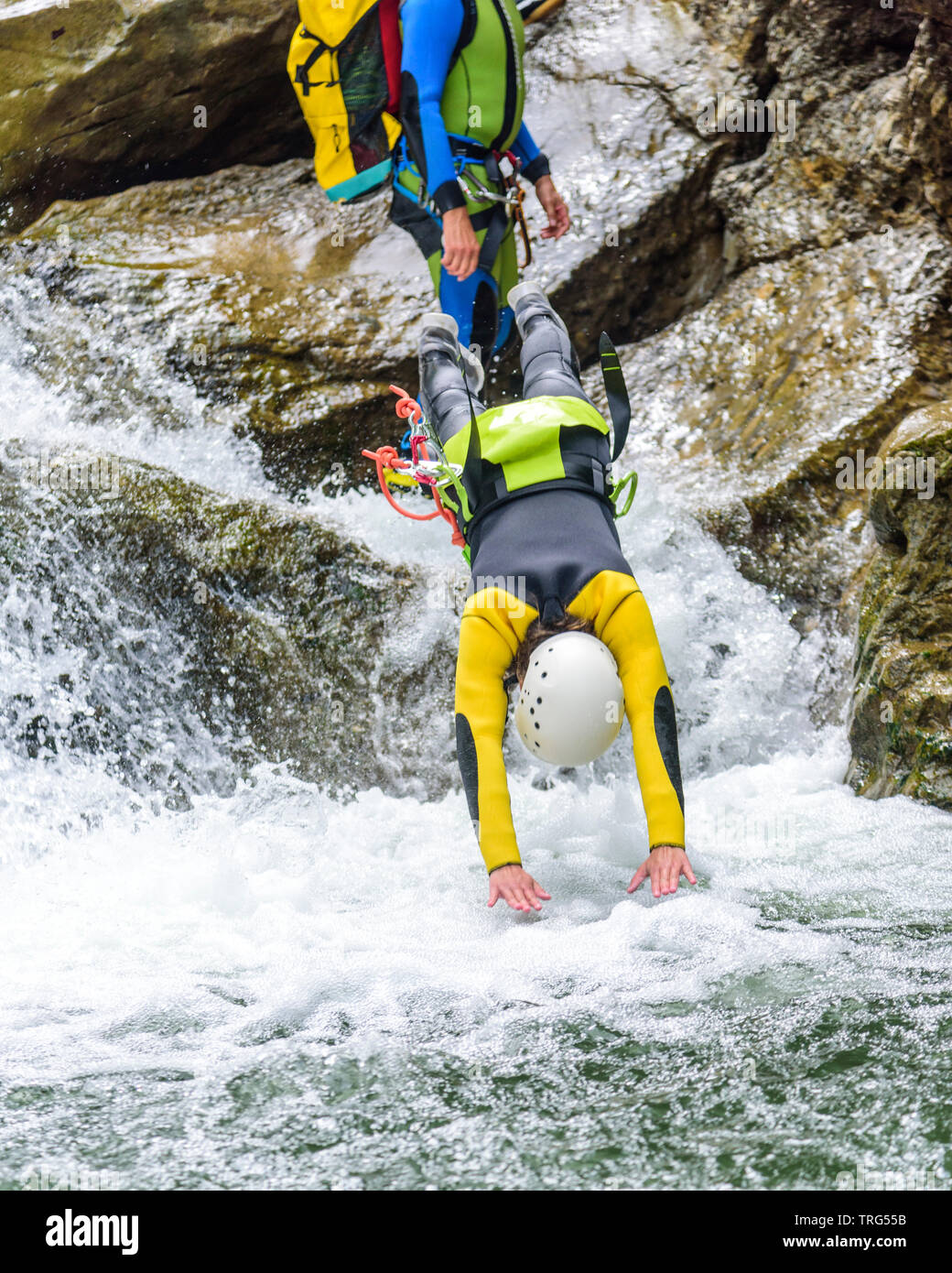 Jumping into water pool during canyoning tour Stock Photo - Alamy