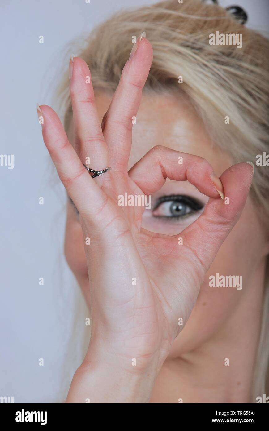 Woman giving OK sign Stock Photo - Alamy