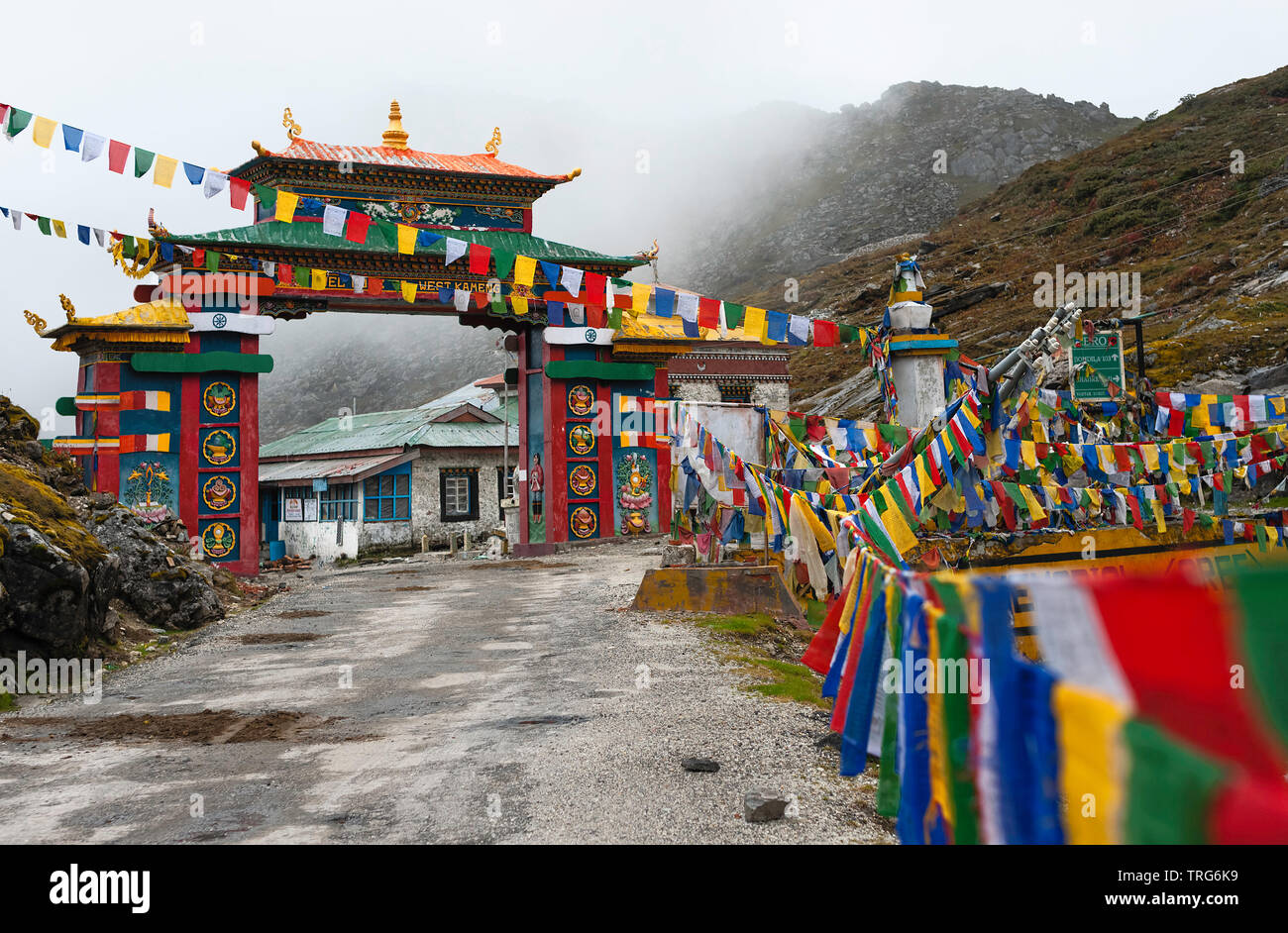 The colourful gateway entrance through Sela Pass on a misty morning in ...
