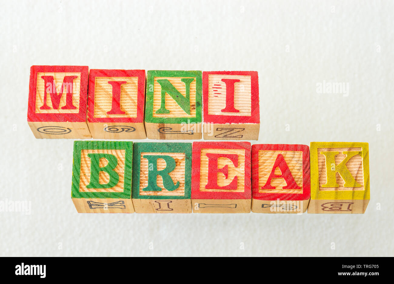 The term mini break visually displayed using colorful wooden blocks on ...