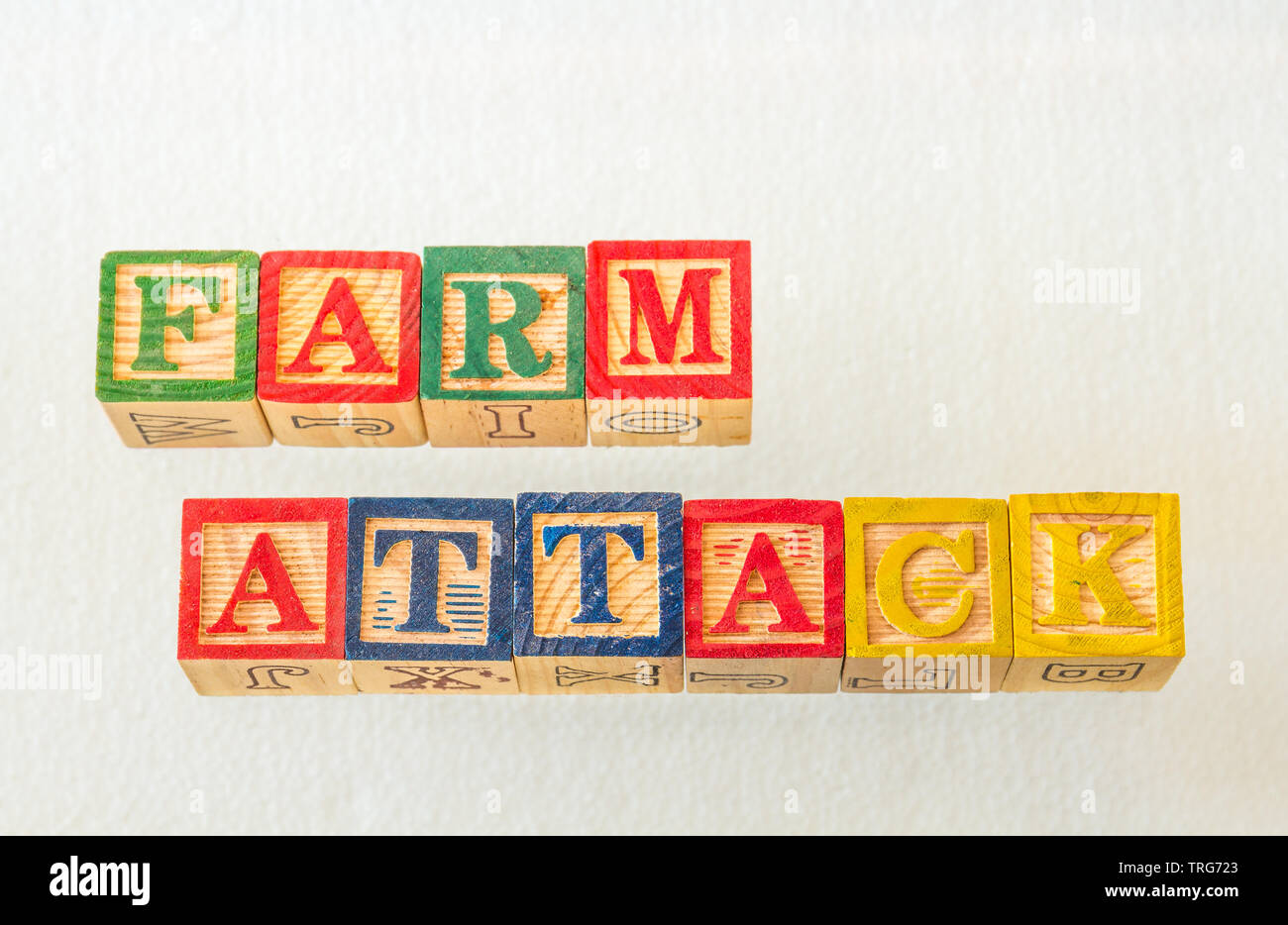 The term farm attack visually displayed using colorful wooden blocks on ...