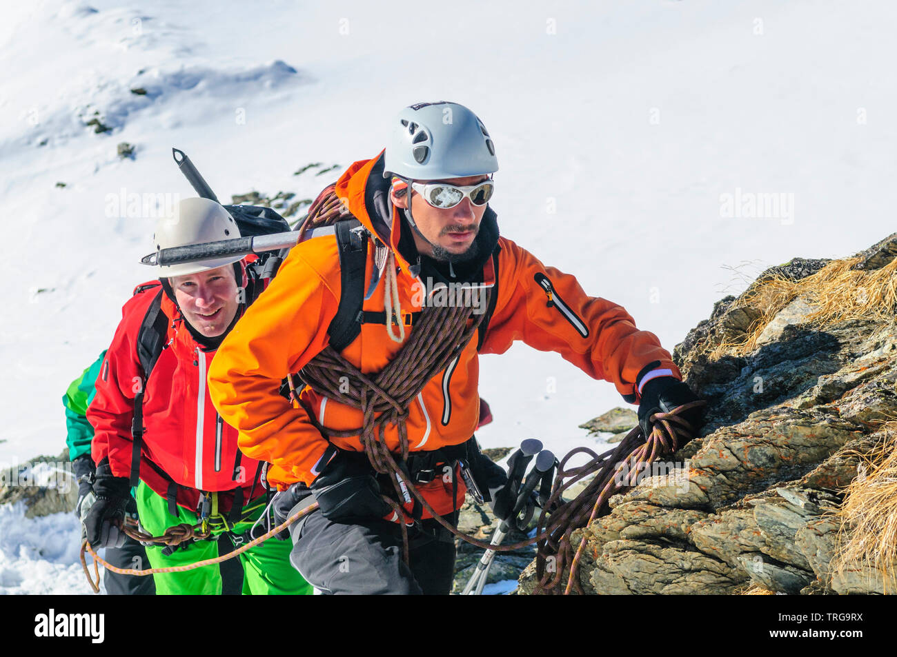 A group of alpinists on the way in high alpine region as a rope team ...