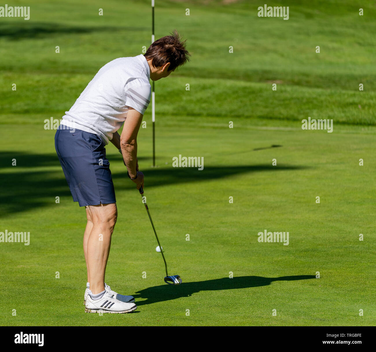 Braunschweig, Germany, May 18, 2019: Middle-aged woman hitting the golf ...