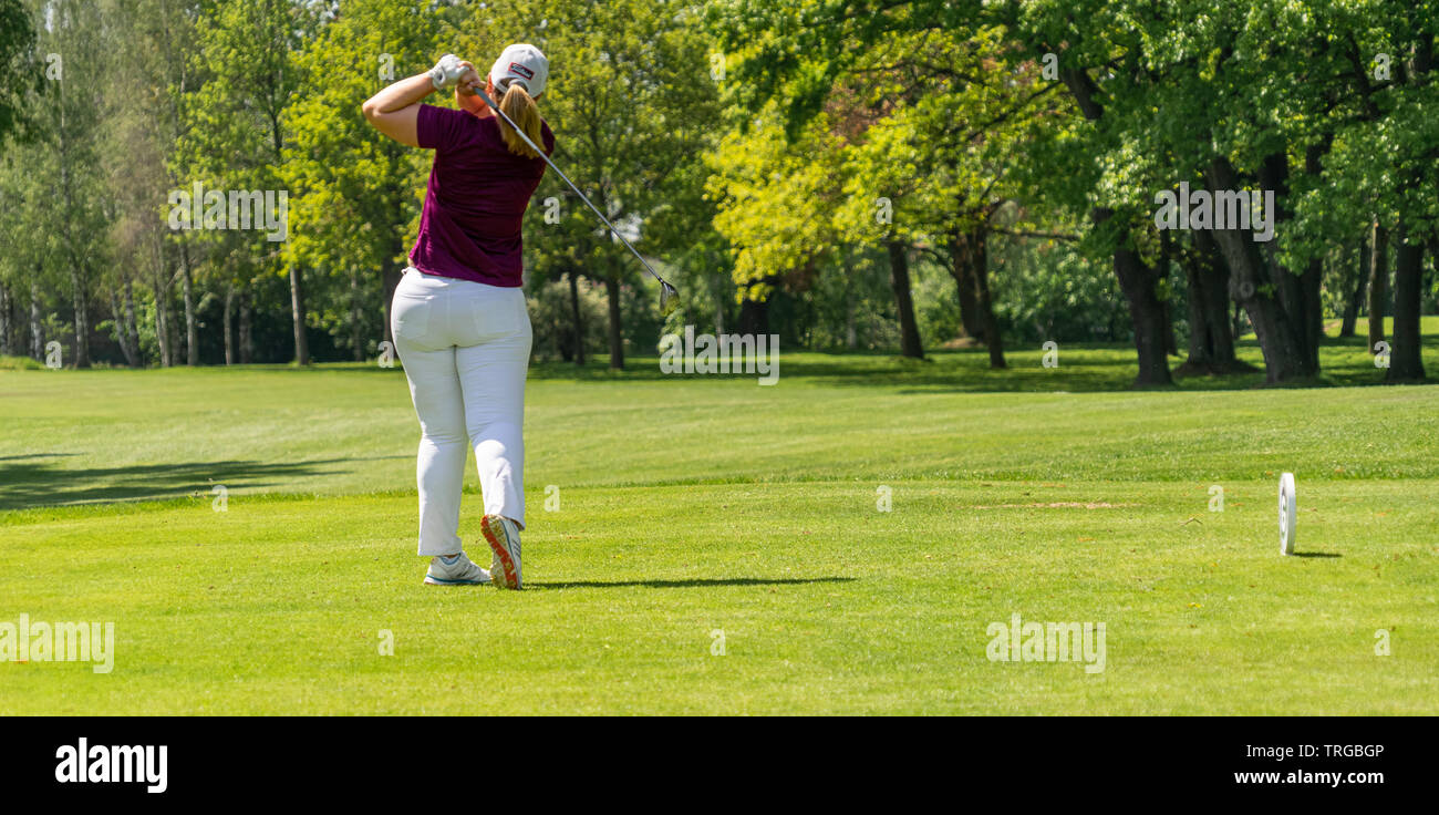 Braunschweig, Germany, May 18, 2019: Middle-aged woman hitting the golf ...
