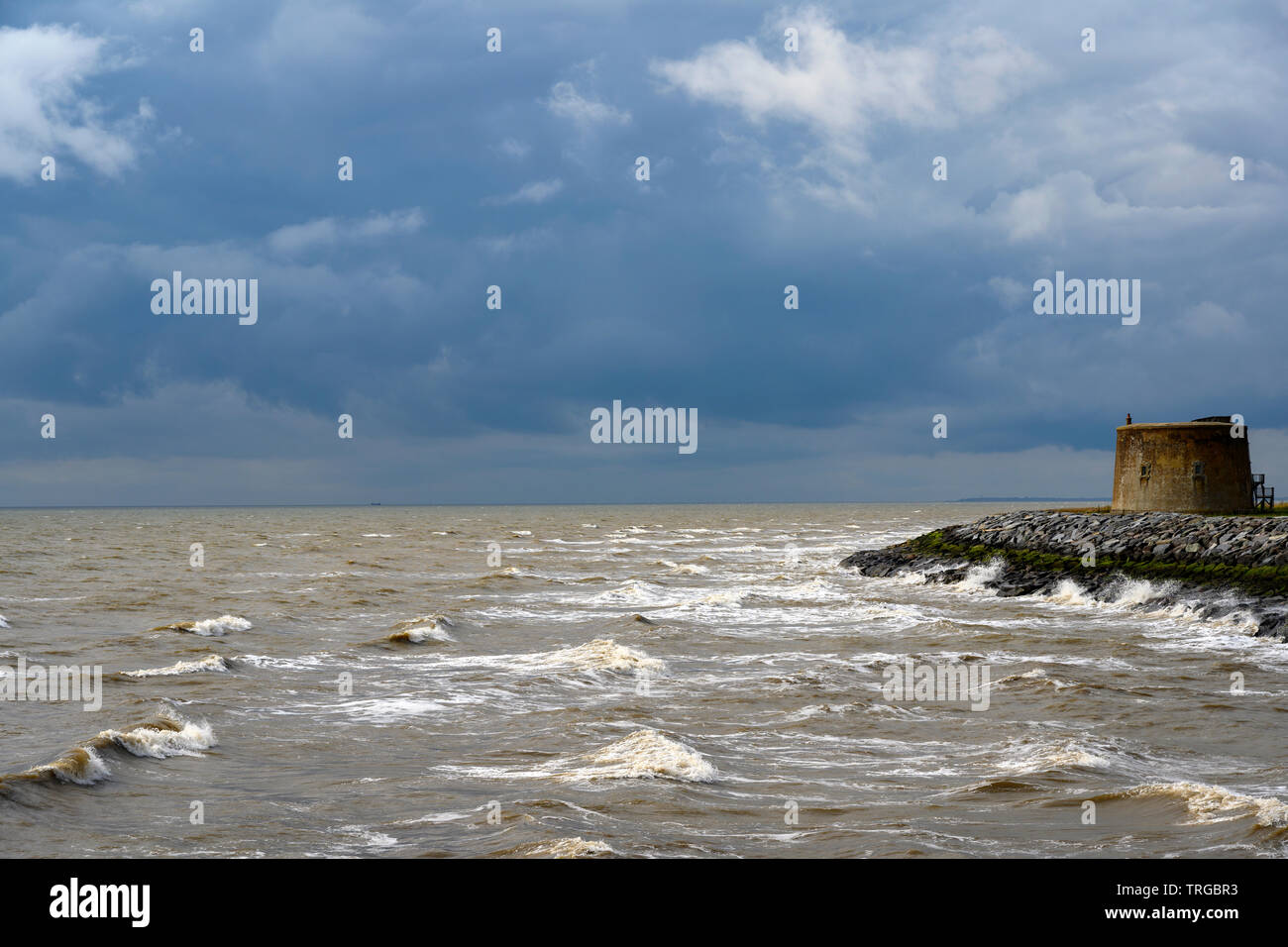 Martello Tower protected from coastal erosion by rock armour, east Lane ...