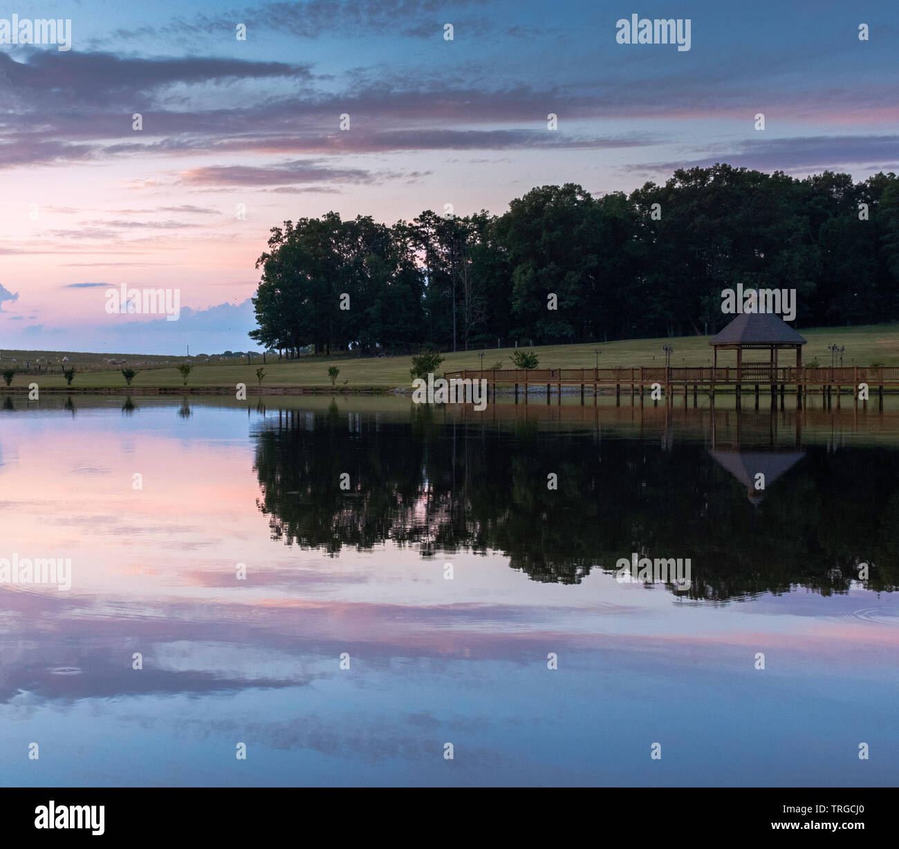 Sunset reflection on a pond in Alabama of a pavillion Stock Photo - Alamy