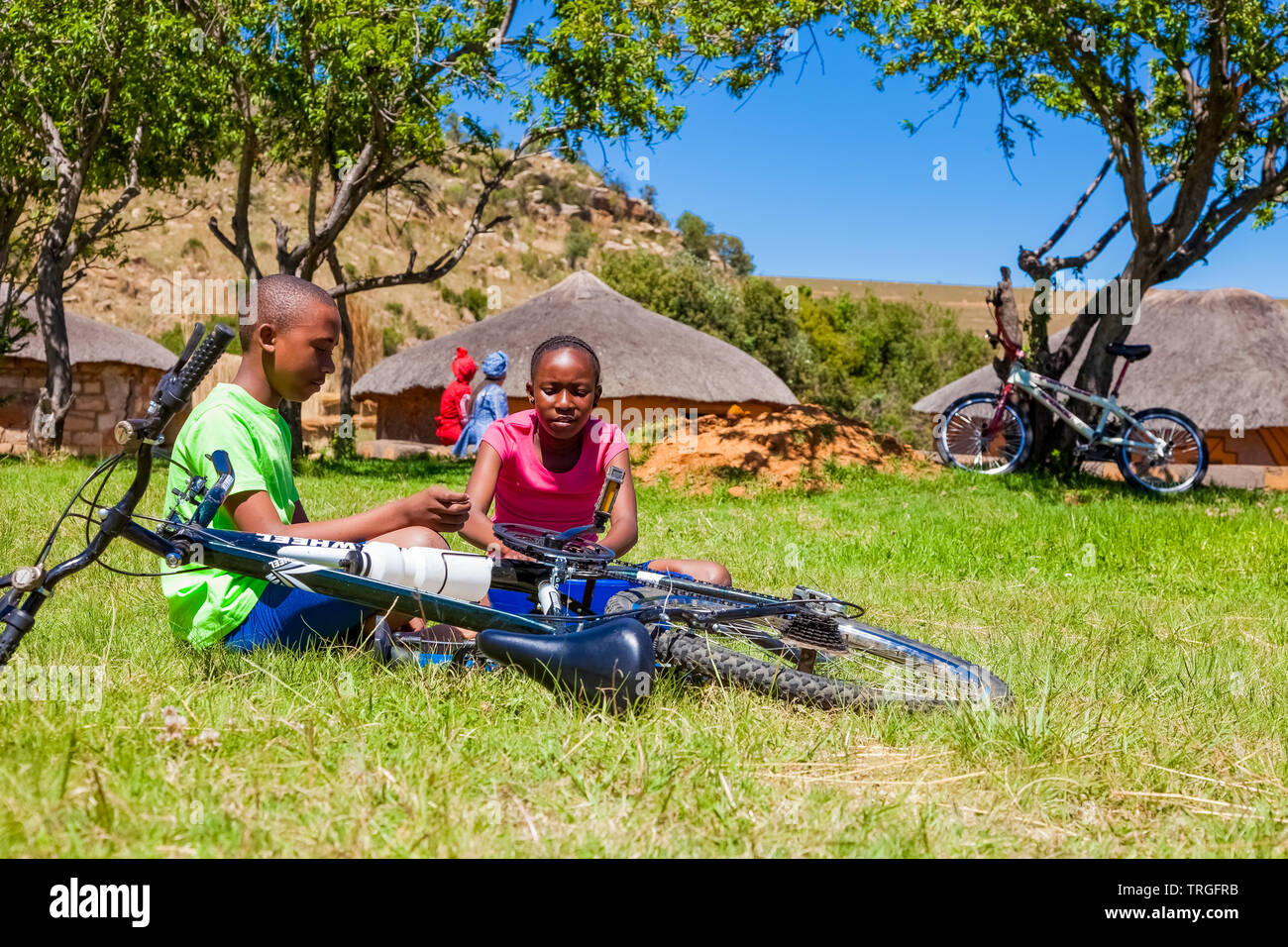 Harrismith, South Africa - October 18 2012: African Children fixing a ...