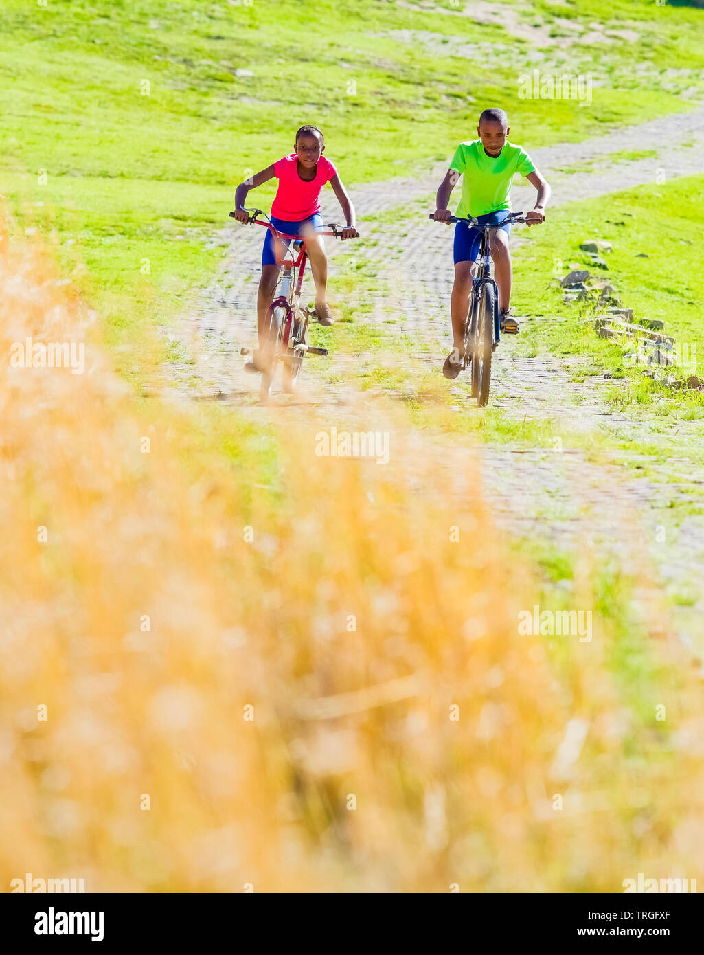 Children riding bike boy girl african hi-res stock photography and ...