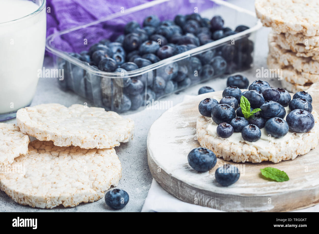 Healthy organic rice cakes with ricotta and fresh blueberries and glass ...