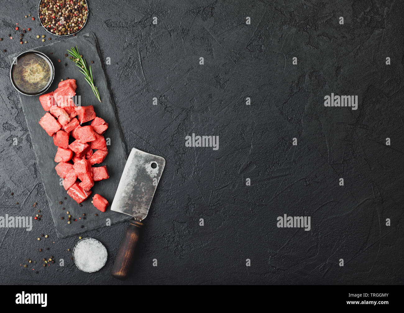 Raw lean diced casserole beef pork steak on chopping board with vintage ...