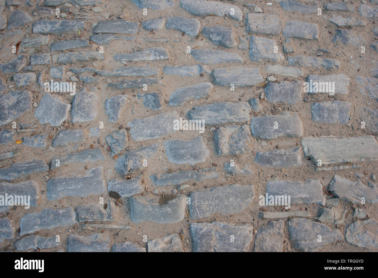 old medieval cobbled road background Stock Photo - Alamy