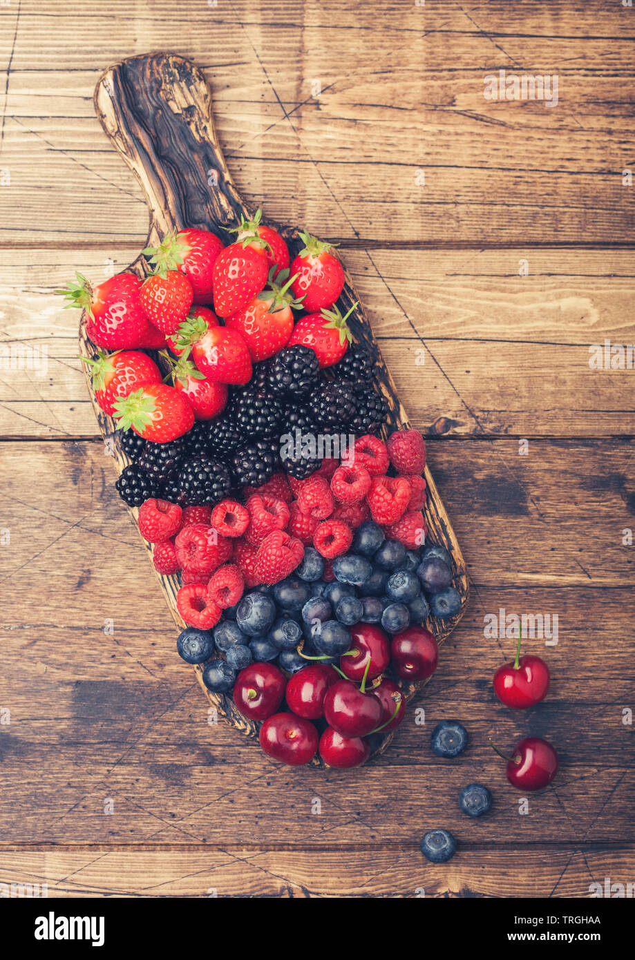 Fresh organic summer berries mix on vintage wooden chopping board on ...