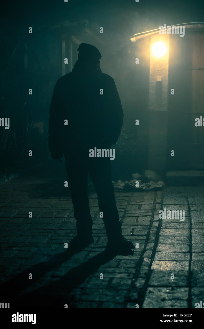 man silhouette and light at night Stock Photo - Alamy