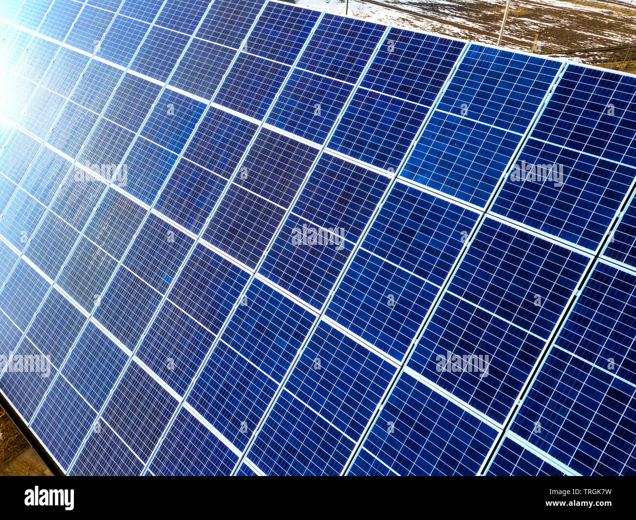 Close-up surface of lit by sun blue shiny solar photo voltaic panels ...