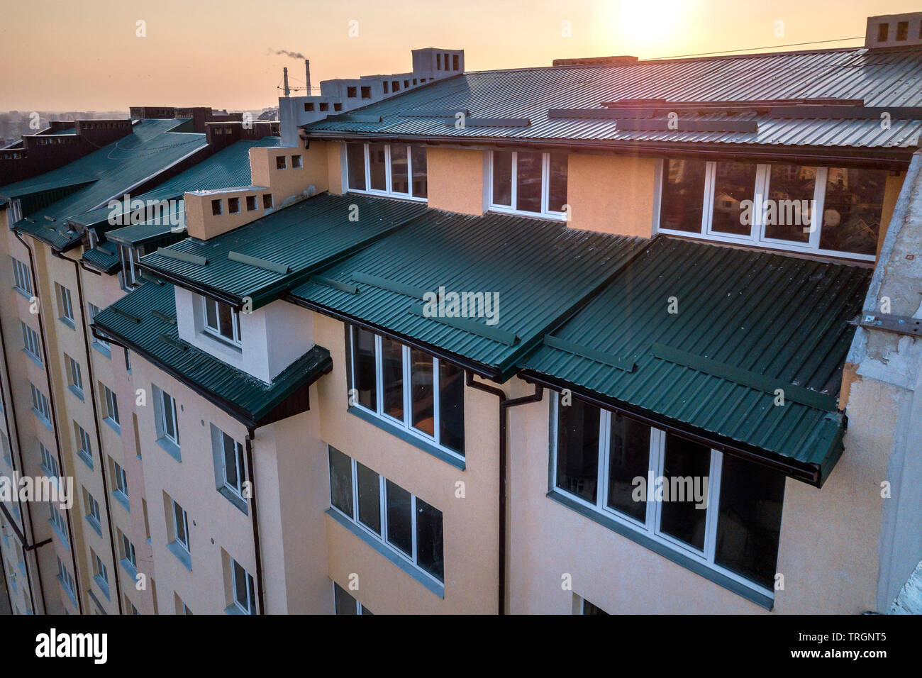 Aerial view of attic annex room exterior with plastic windows, roof and ...
