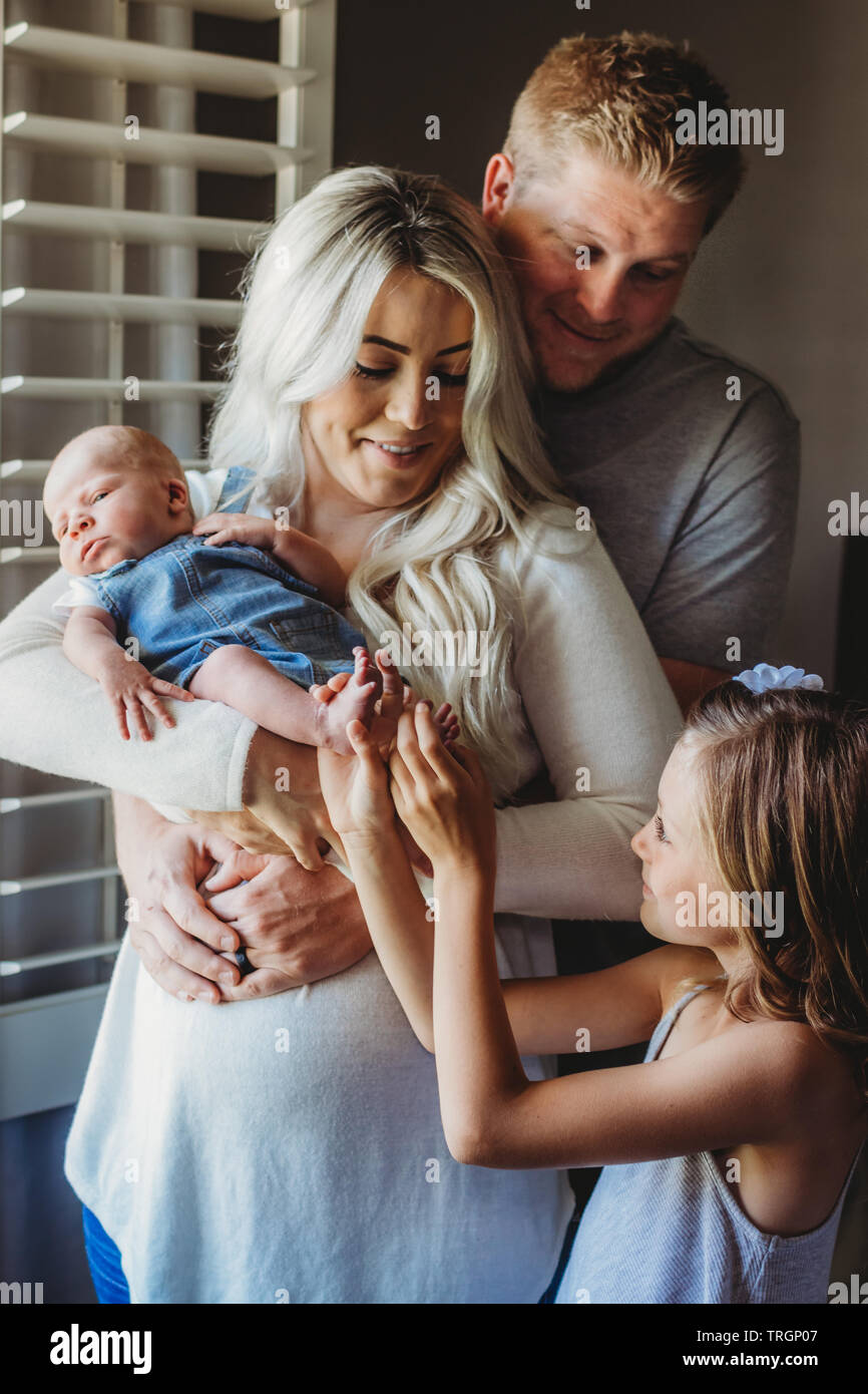 family at home with a new baby in the nursery Stock Photo - Alamy