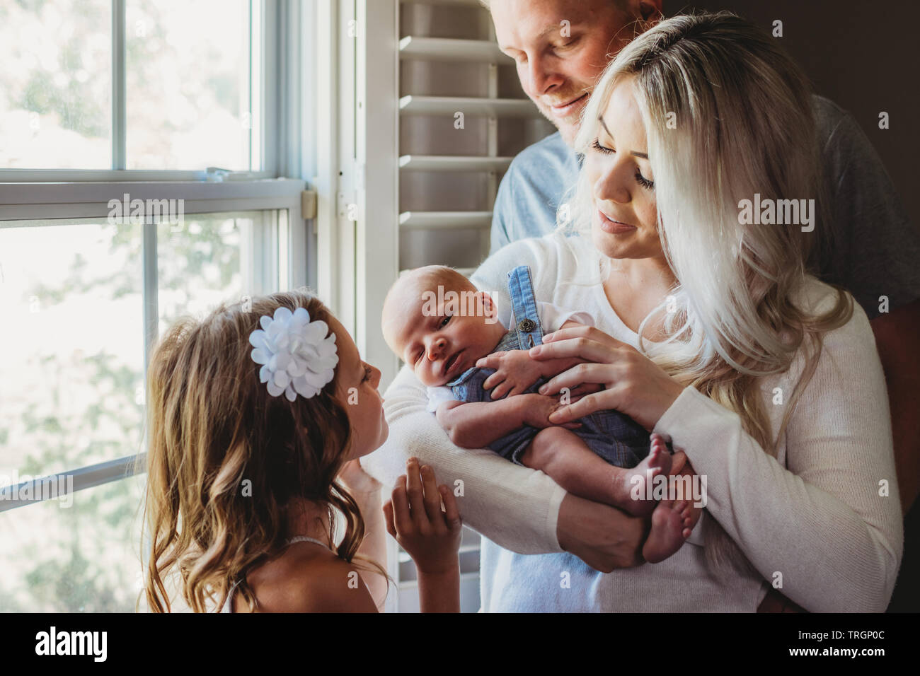 family at home with a new baby in the nursery Stock Photo - Alamy