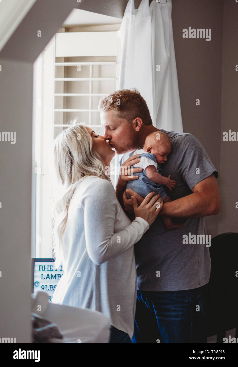 family at home with a new baby in the nursery Stock Photo - Alamy