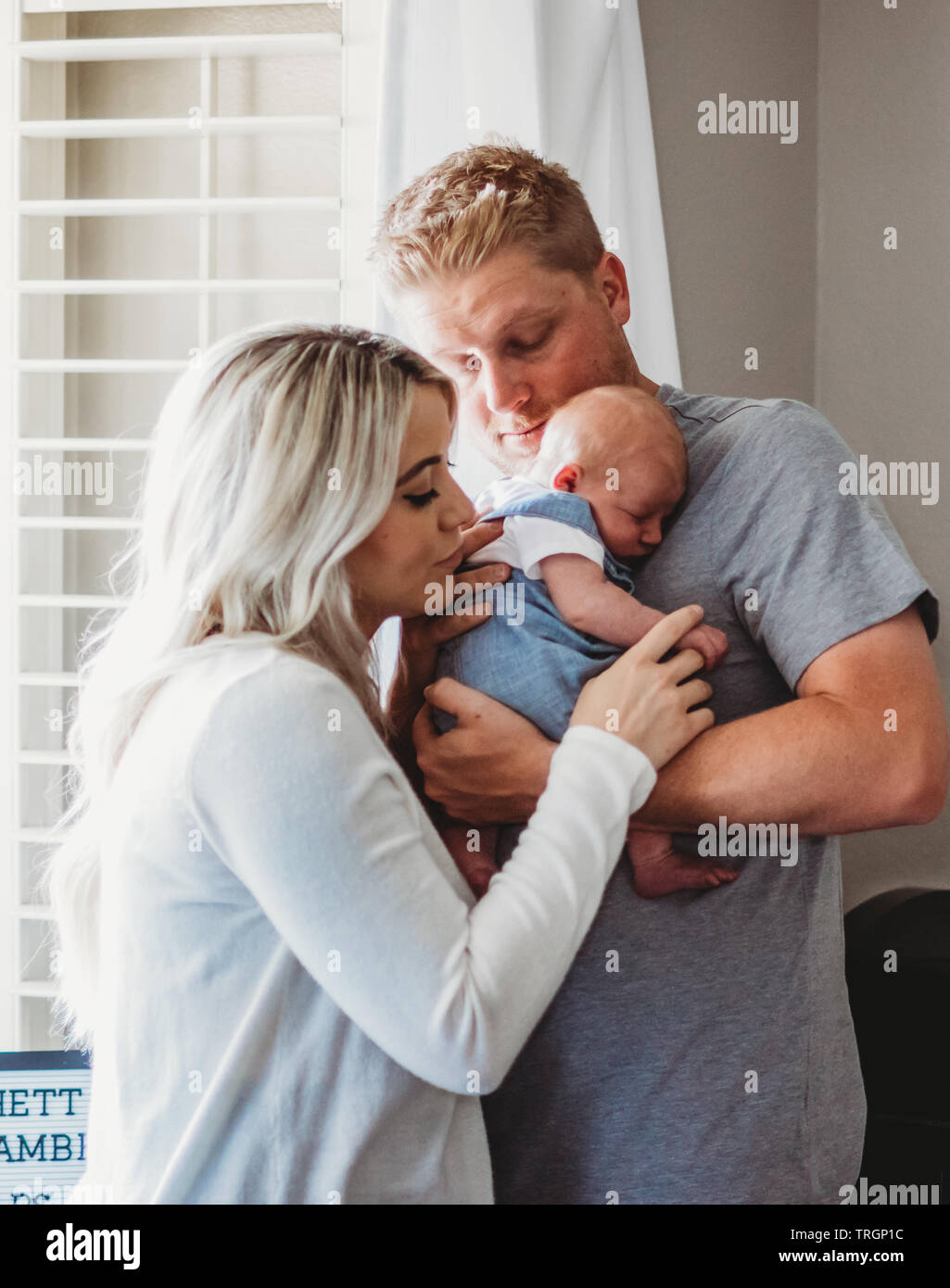 family at home with a new baby in the nursery Stock Photo - Alamy
