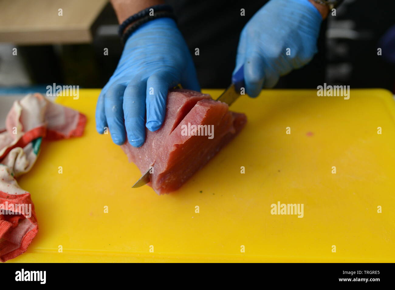 Male chef cuts red fish hi-res stock photography and images - Alamy