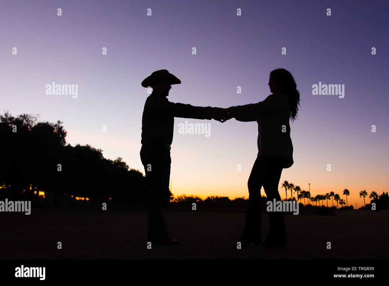 Country Family in the sunset dancing and jumping Stock Photo - Alamy