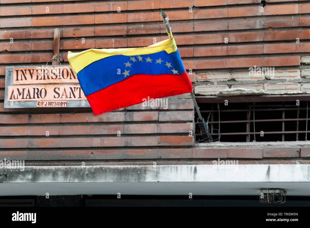 Flag of Venezuela waving from the window of a shop in the center of ...