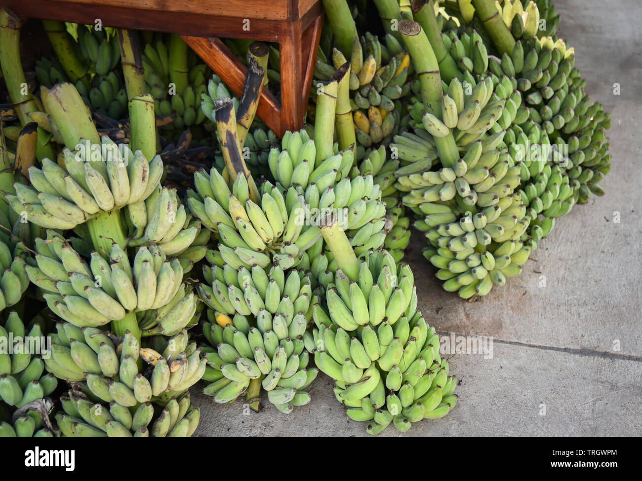 green banana for sale in the local market fruit asian Stock Photo - Alamy
